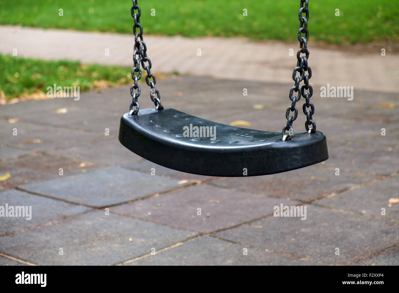 Empty chain swing in playground in city Stock Photo - Alamy