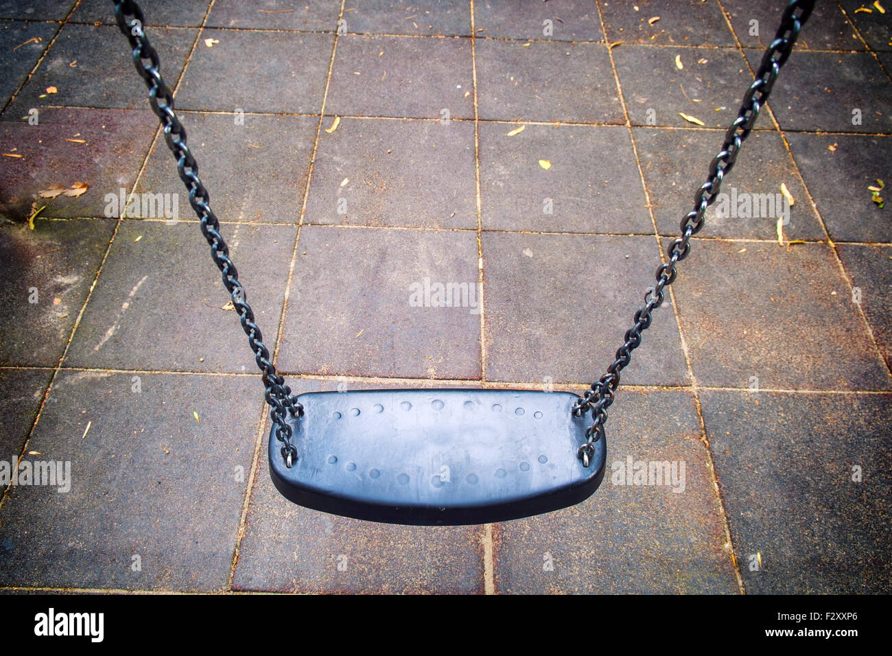 Empty chain swing in playground in city Stock Photo - Alamy