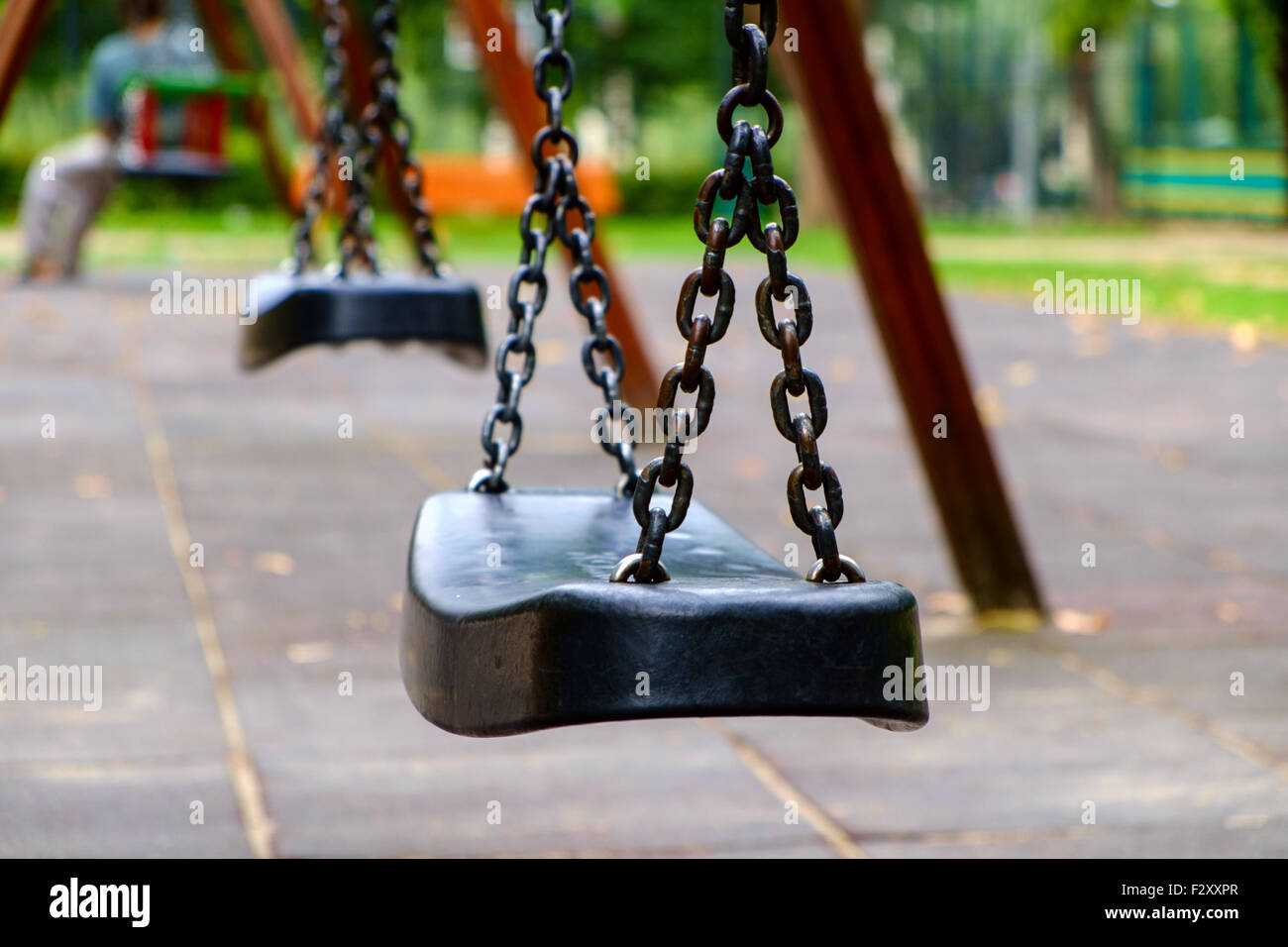 Empty chain swing in playground in city Stock Photo - Alamy
