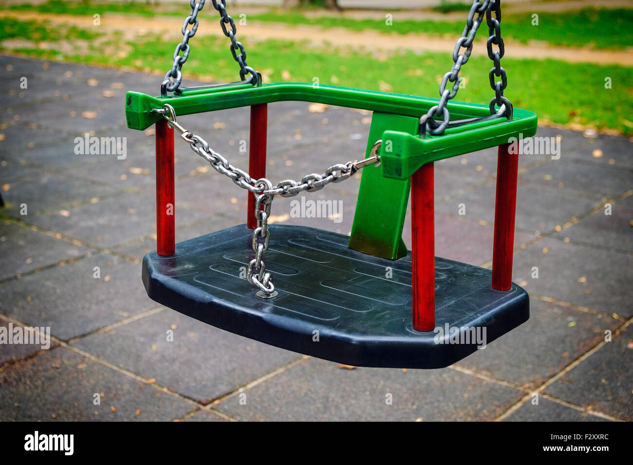 Empty chain swing in playground in city Stock Photo - Alamy