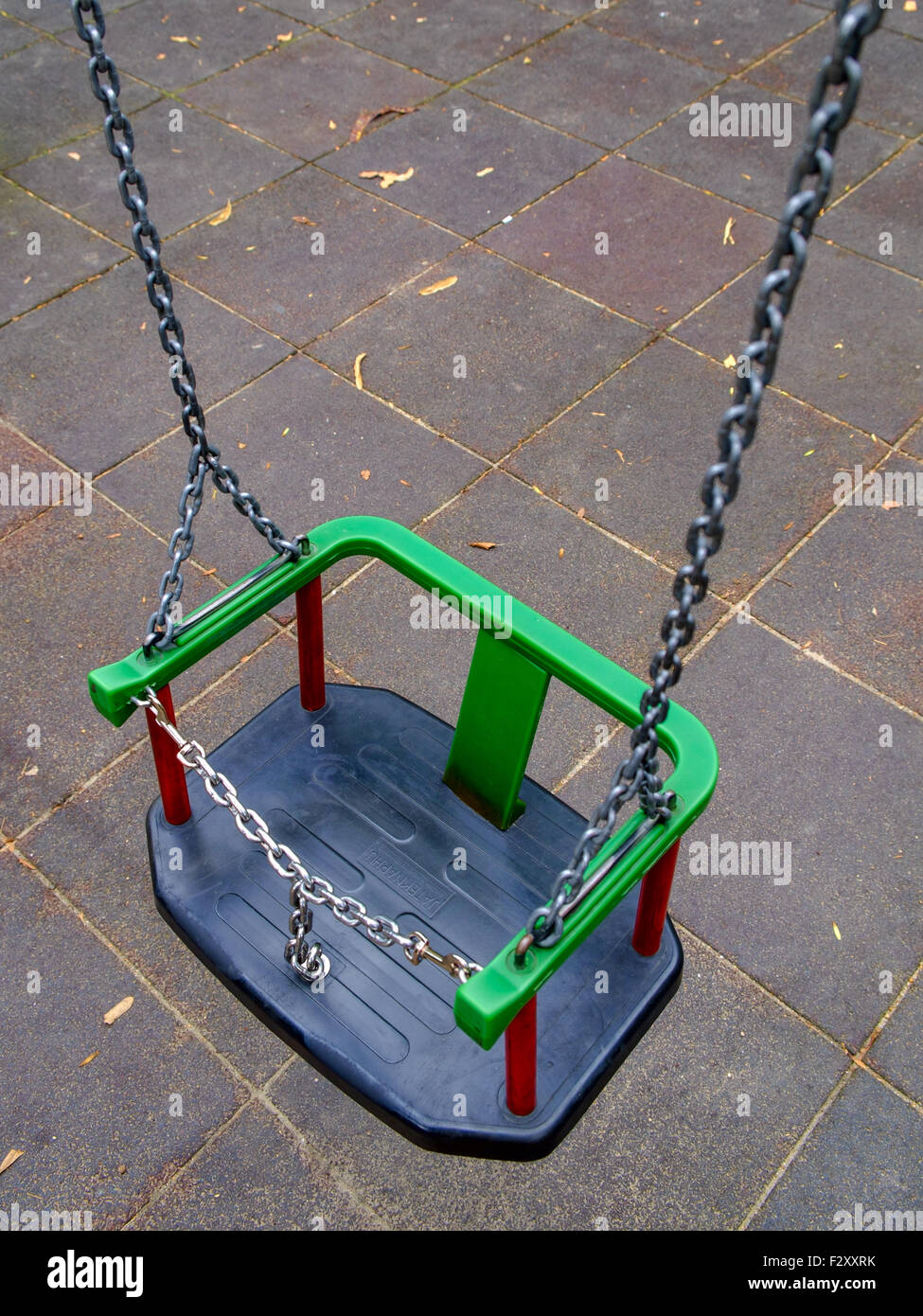 Empty chain swing in playground in city Stock Photo - Alamy