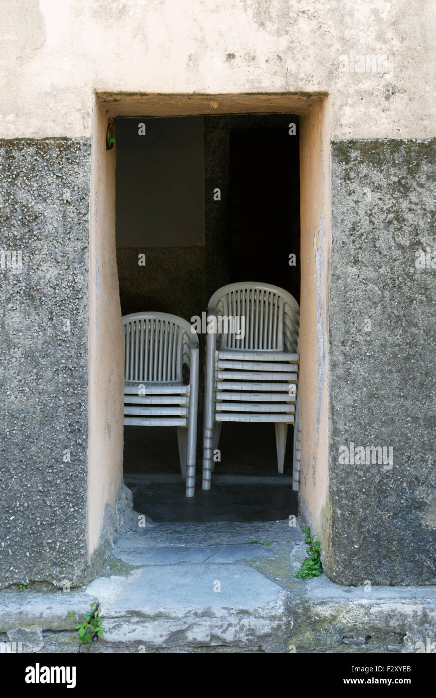 Piled chairs inside a rural house Stock Photo - Alamy