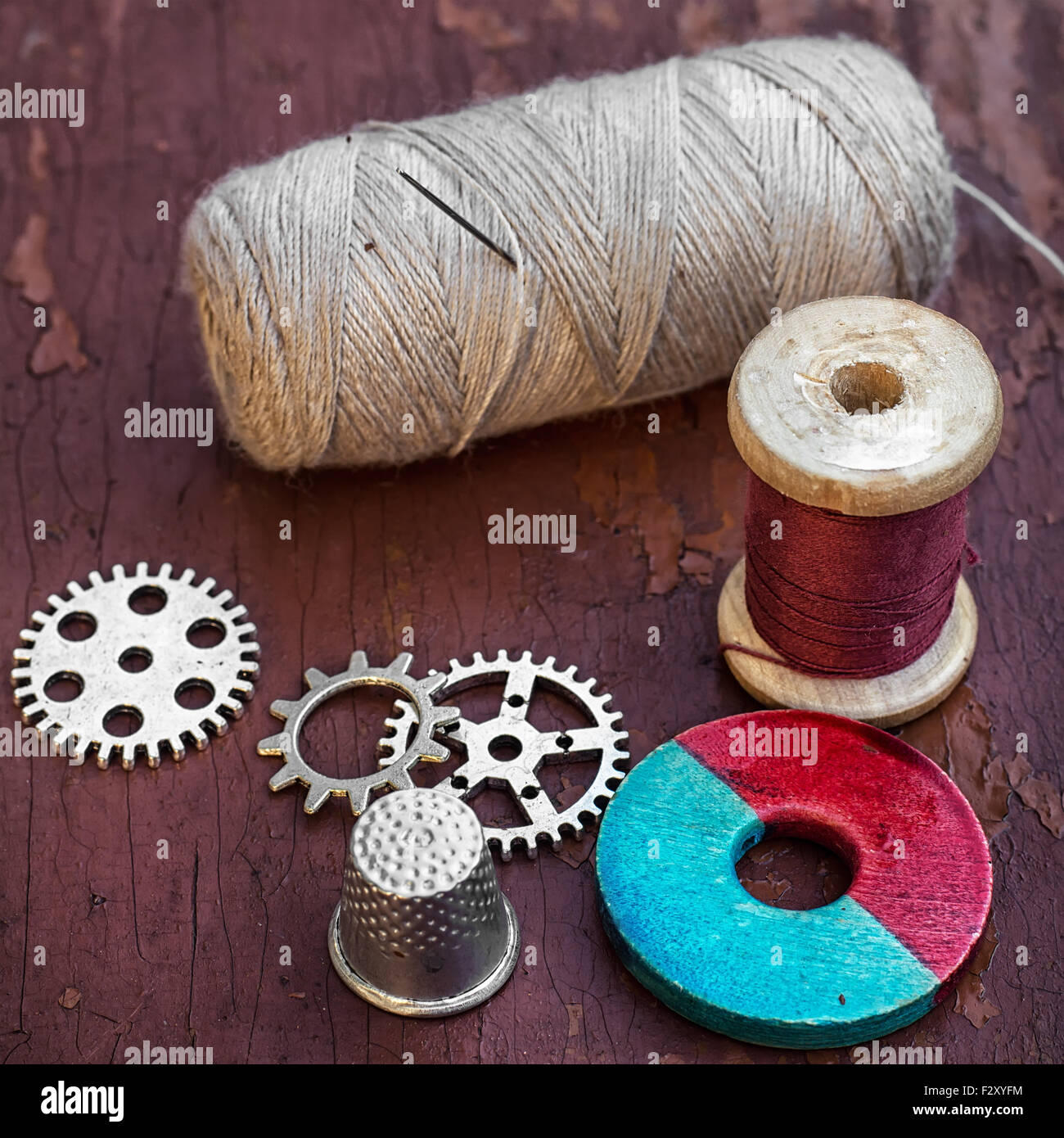set of threads and buttons on old wooden background Stock Photo - Alamy
