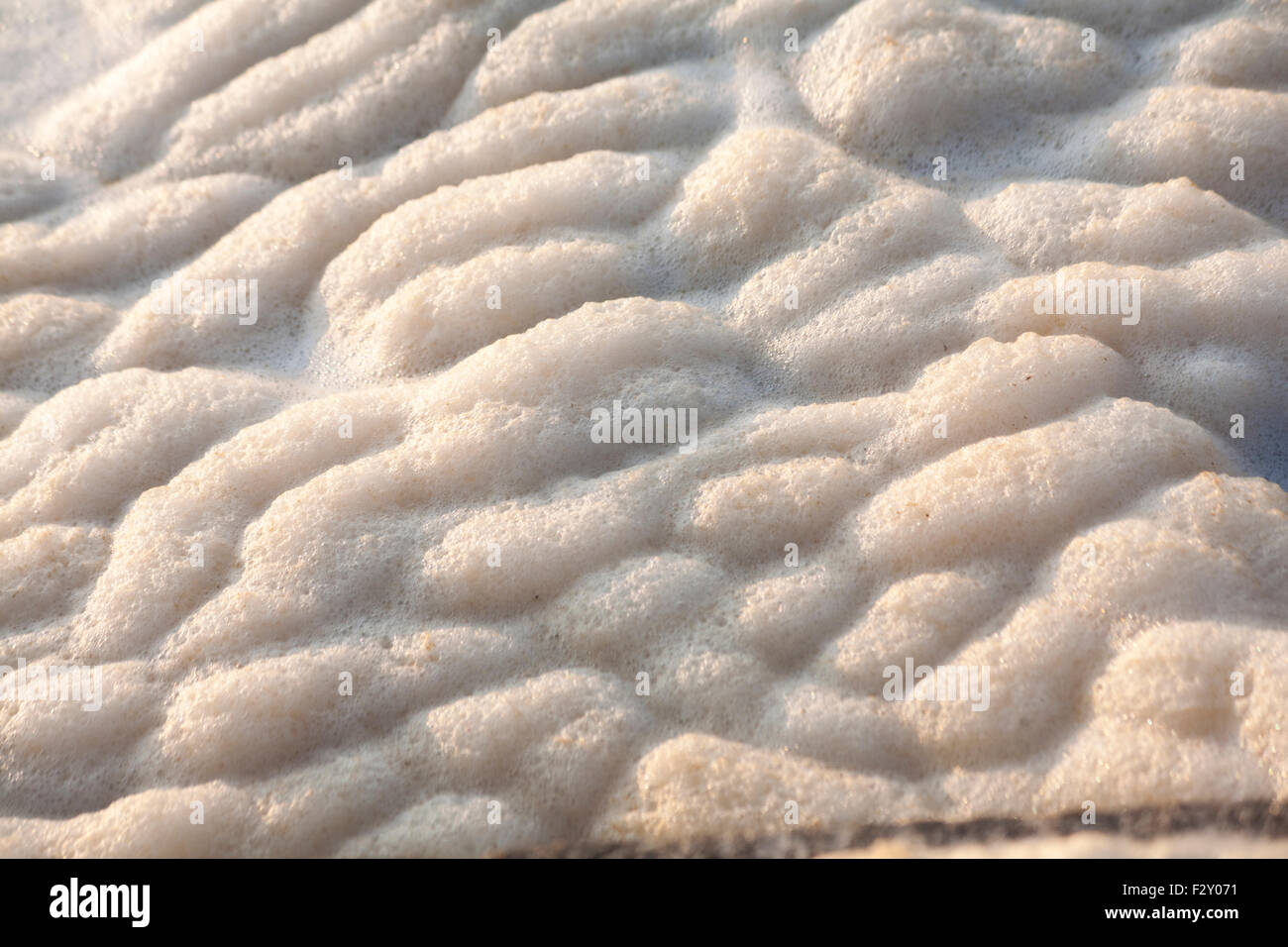 Foam scum abstract patterns on surface of lake Stock Photo - Alamy