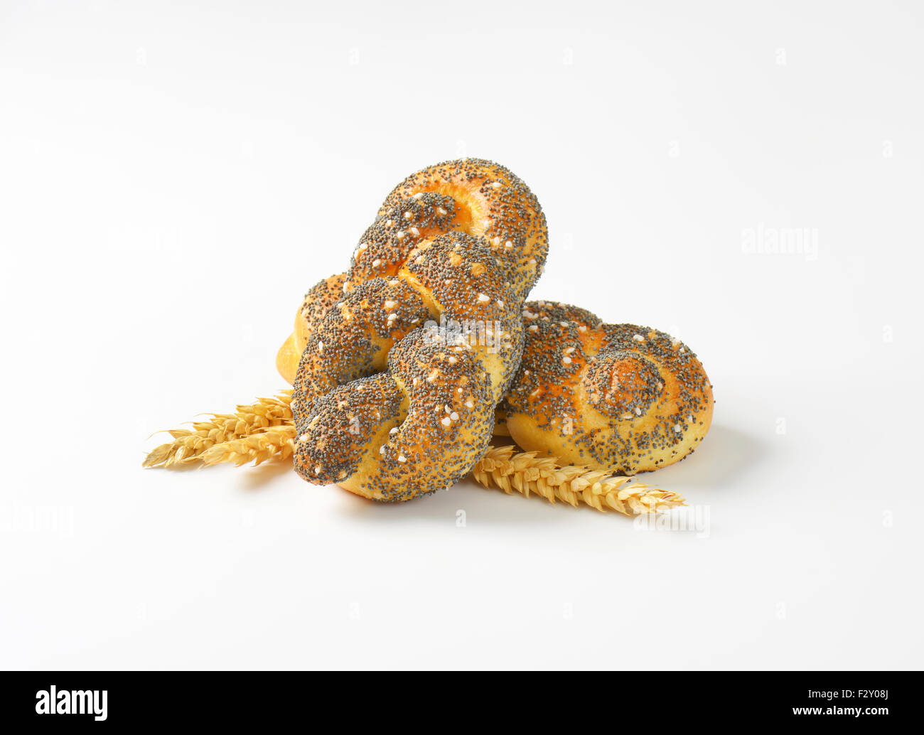 Braided bread rolls topped with poppy seeds and salt Stock Photo - Alamy