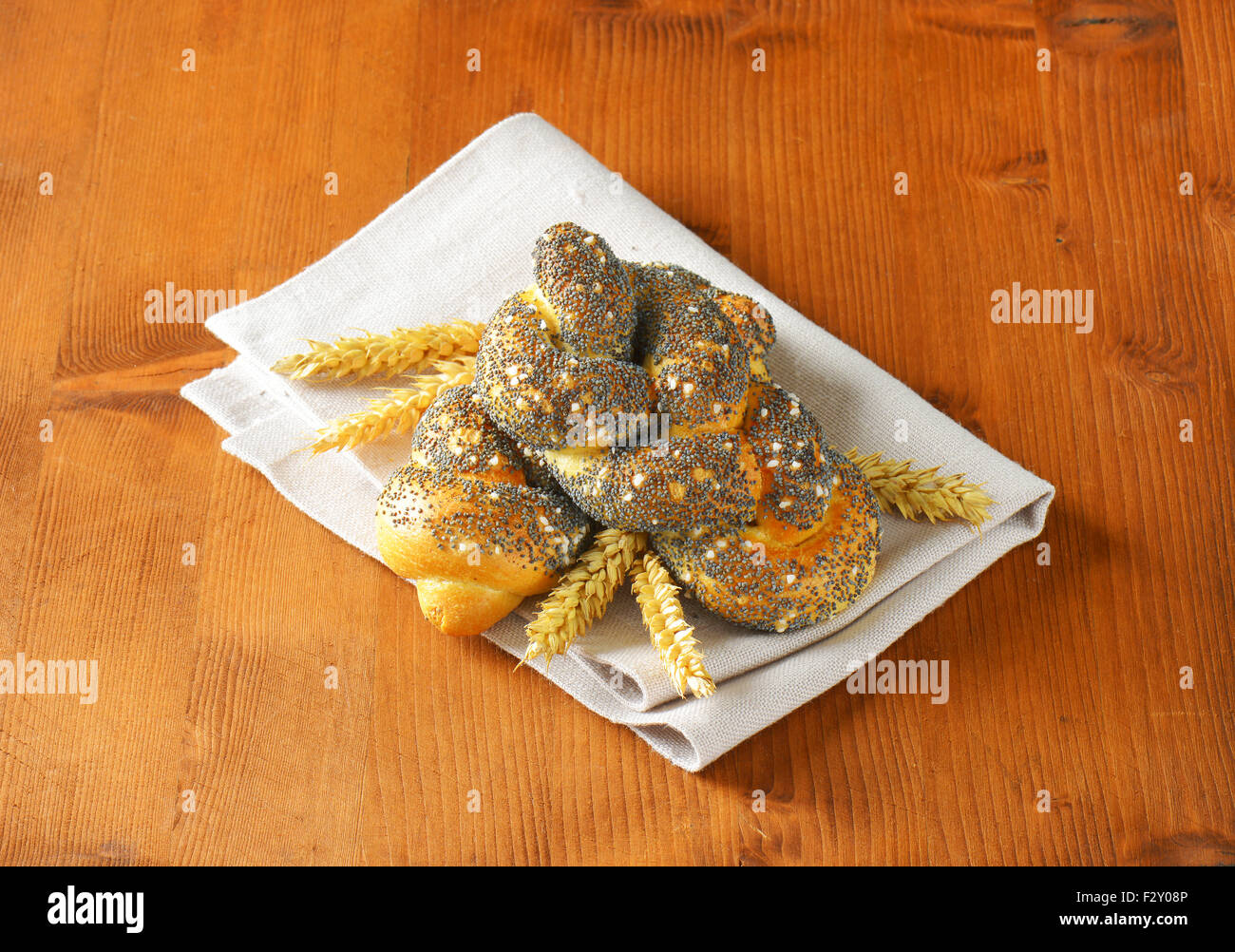 Braided bread rolls topped with poppy seeds and salt Stock Photo - Alamy