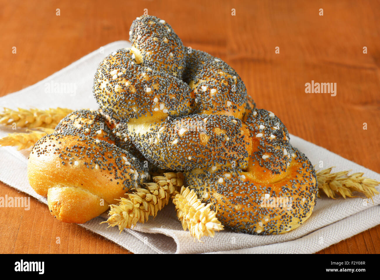 Braided bread rolls topped with poppy seeds and salt Stock Photo - Alamy