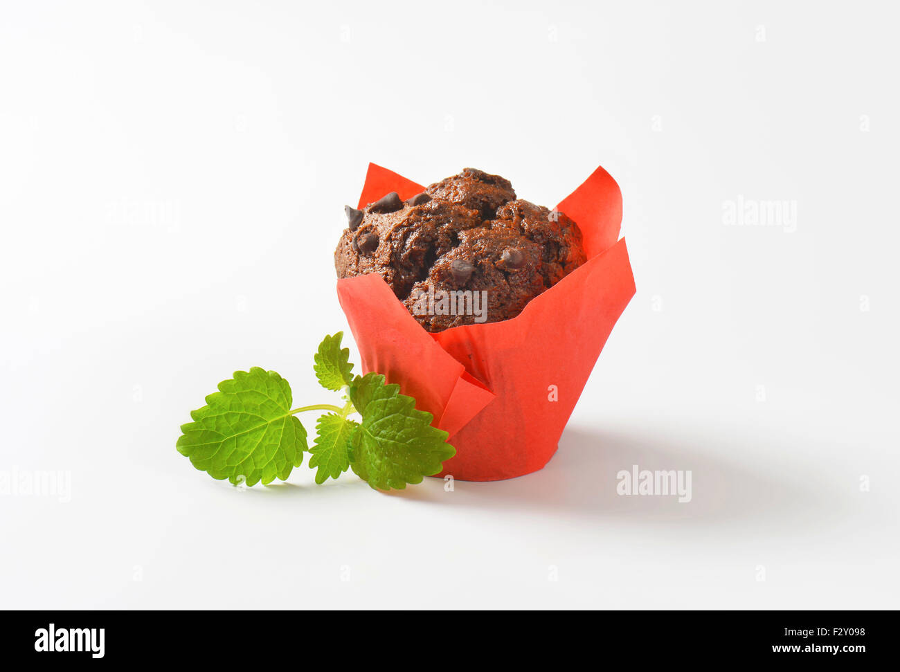 Double chocolate chip muffin wrapped in red paper Stock Photo - Alamy