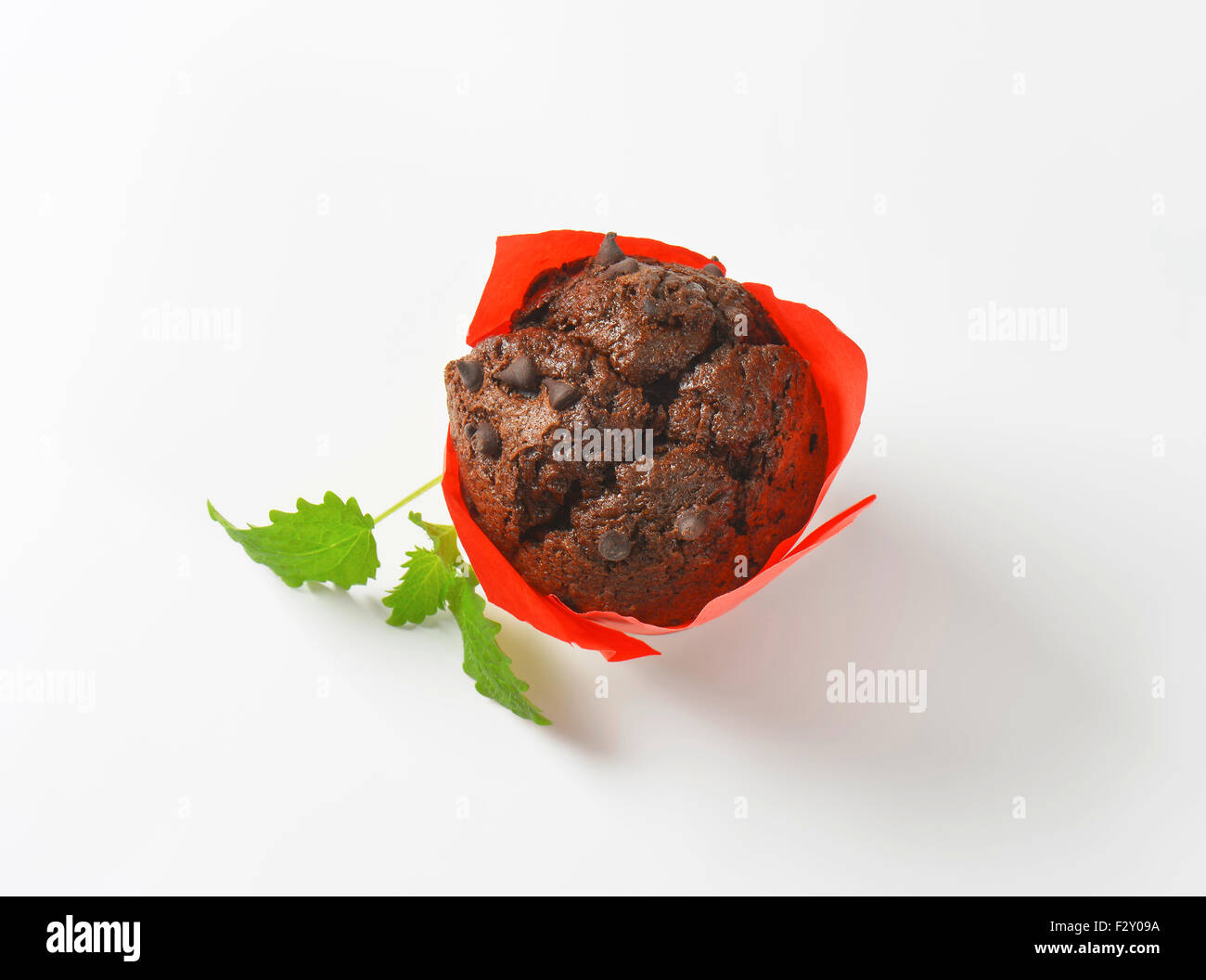 Double chocolate chip muffin wrapped in red paper Stock Photo - Alamy