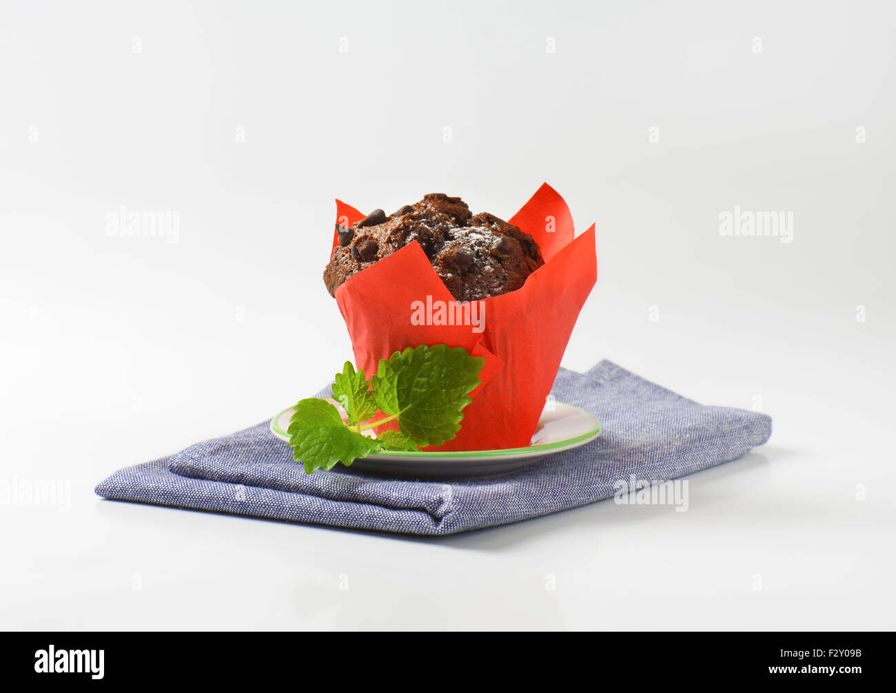 Double chocolate chip muffin wrapped in red paper Stock Photo - Alamy