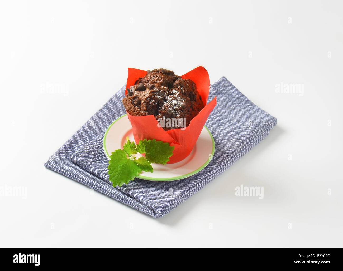 Double chocolate chip muffin wrapped in red paper Stock Photo - Alamy
