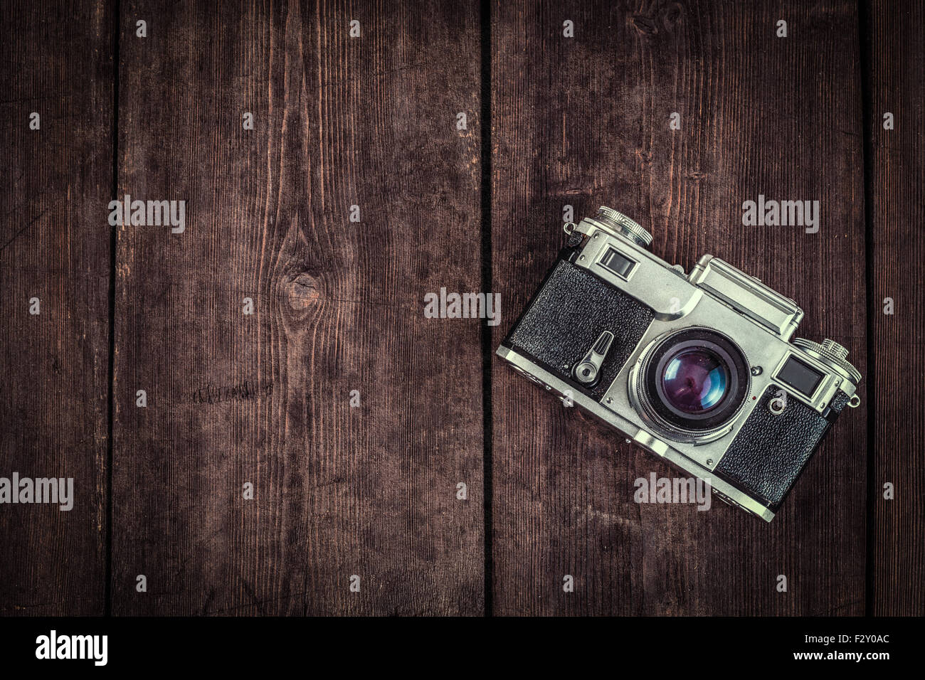 Old retro vintage camera on grunge wooden background Stock Photo - Alamy