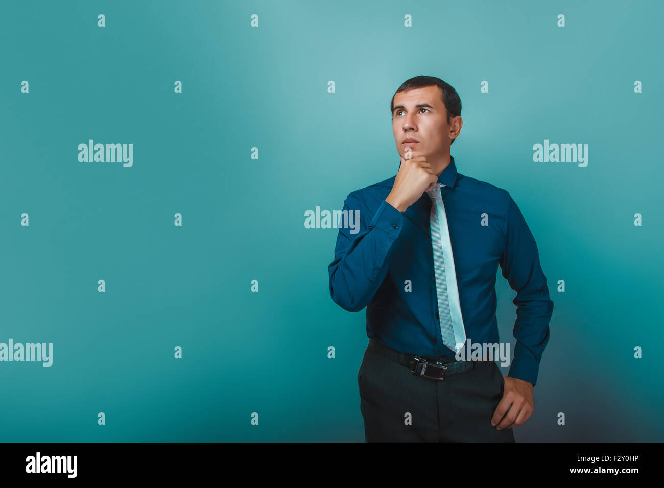 a man of European appearance thirty years thinking hand on chin on a ...