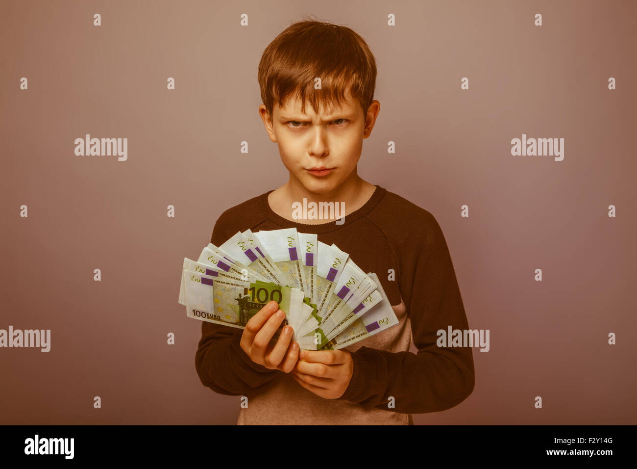 baby boy teenager European appearance brown hair holding bills and ...