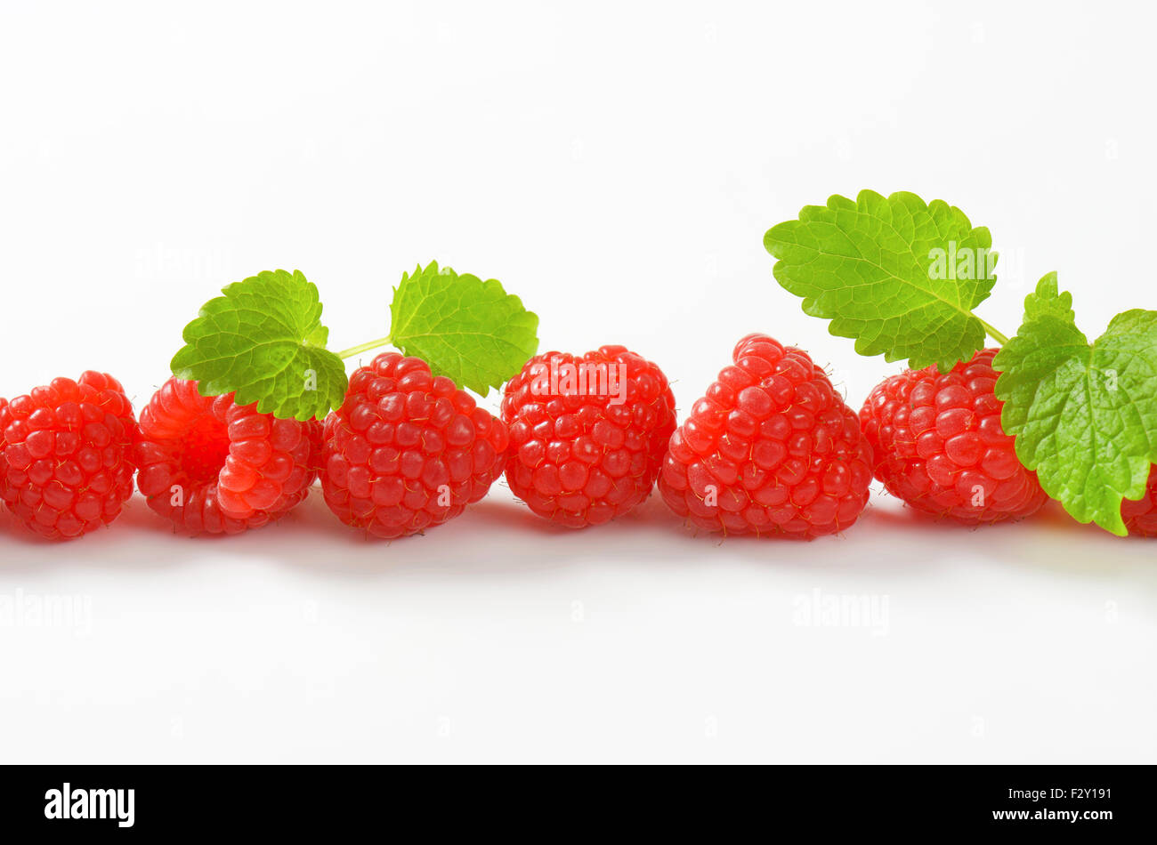 Fresh raspberries in a row Stock Photo - Alamy