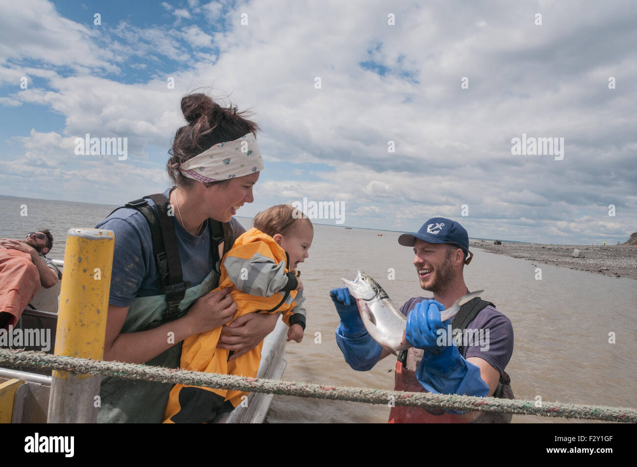 Fishing family-Mom, daughter and Dad hold sockeye salmon. Graveyard ...