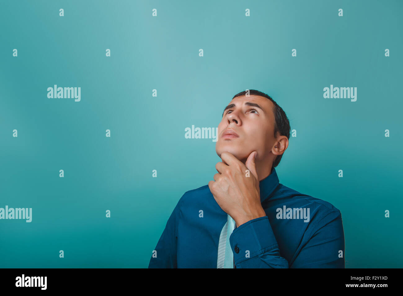 a man of European appearance thirty years thinking hand on chin on a ...