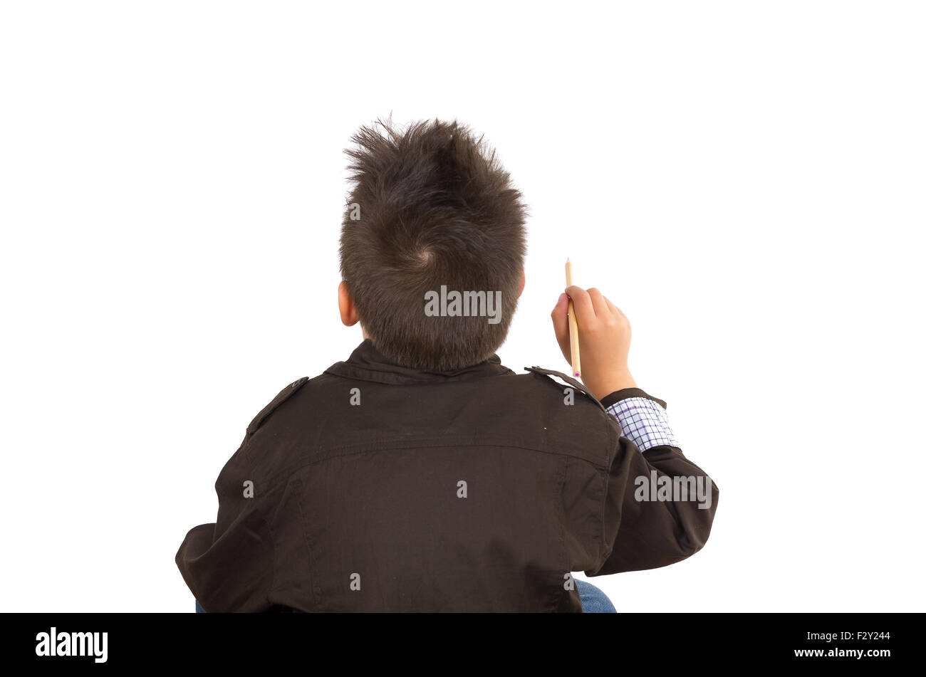 Little boy facing backwards, drawing in the air, isolated over white ...