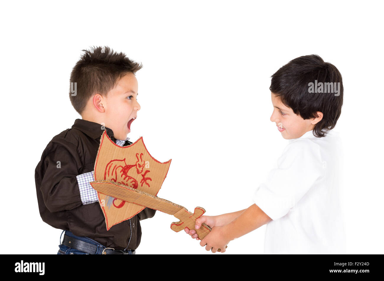 Two small boys simluating sword fight using toys and homemade shield ...