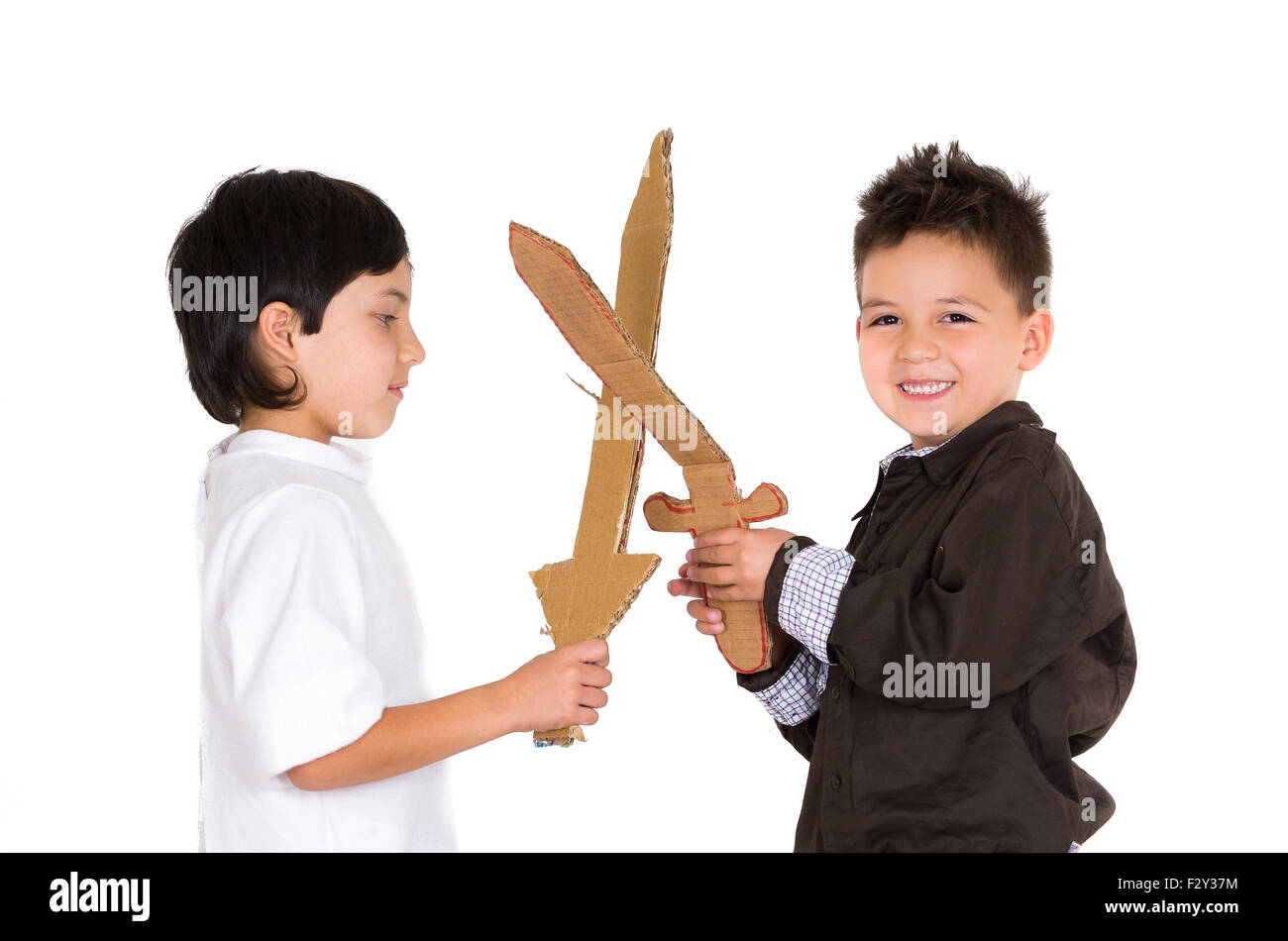 Two small boys simluating sword fight using toys and homemade shield ...
