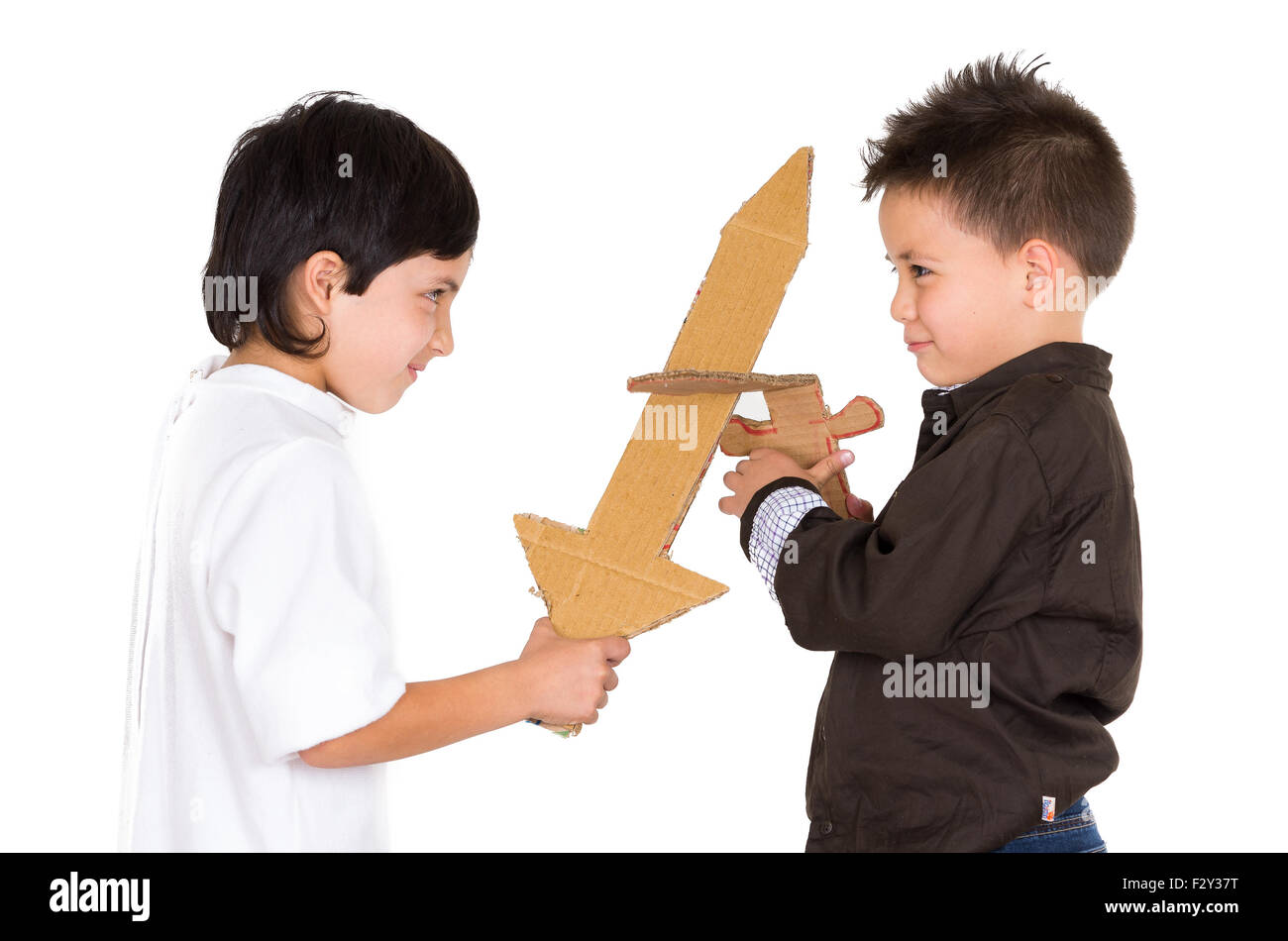 Two small boys simluating sword fight using toys and homemade shield ...