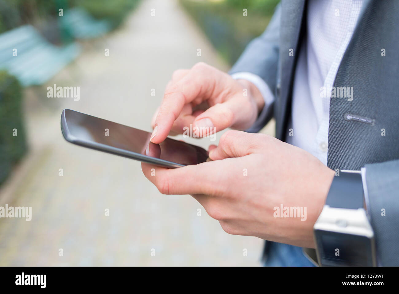 Man with Mobile phone connected to a smart watch; Close-up hands Stock ...