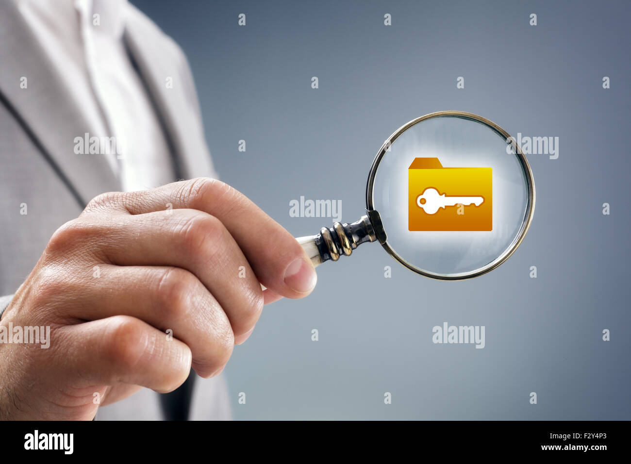Businessman with magnifying glass over file, folder or document icon ...