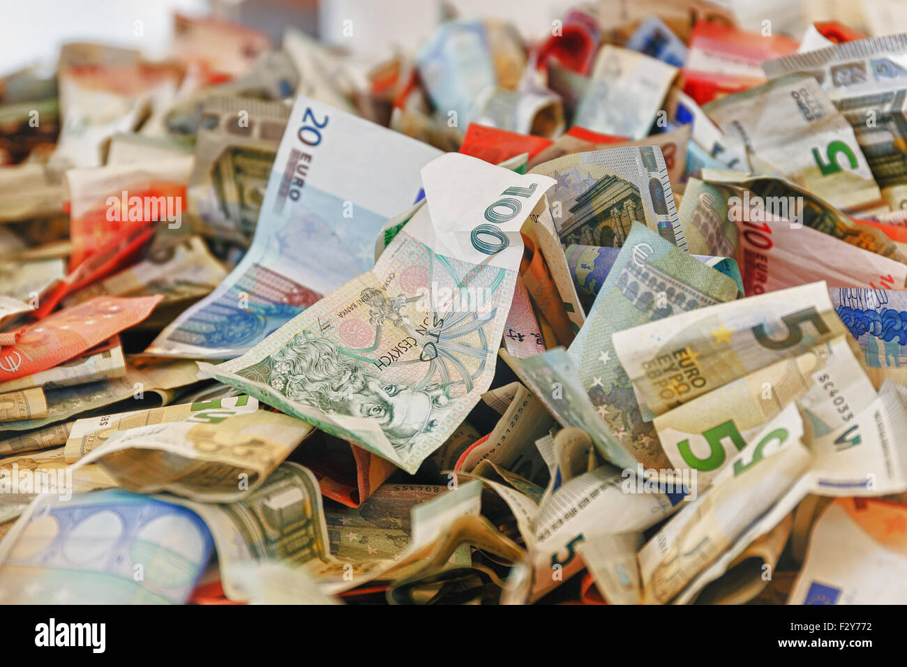 Banknotes of different countries and wrinkled overlapping randomly ...