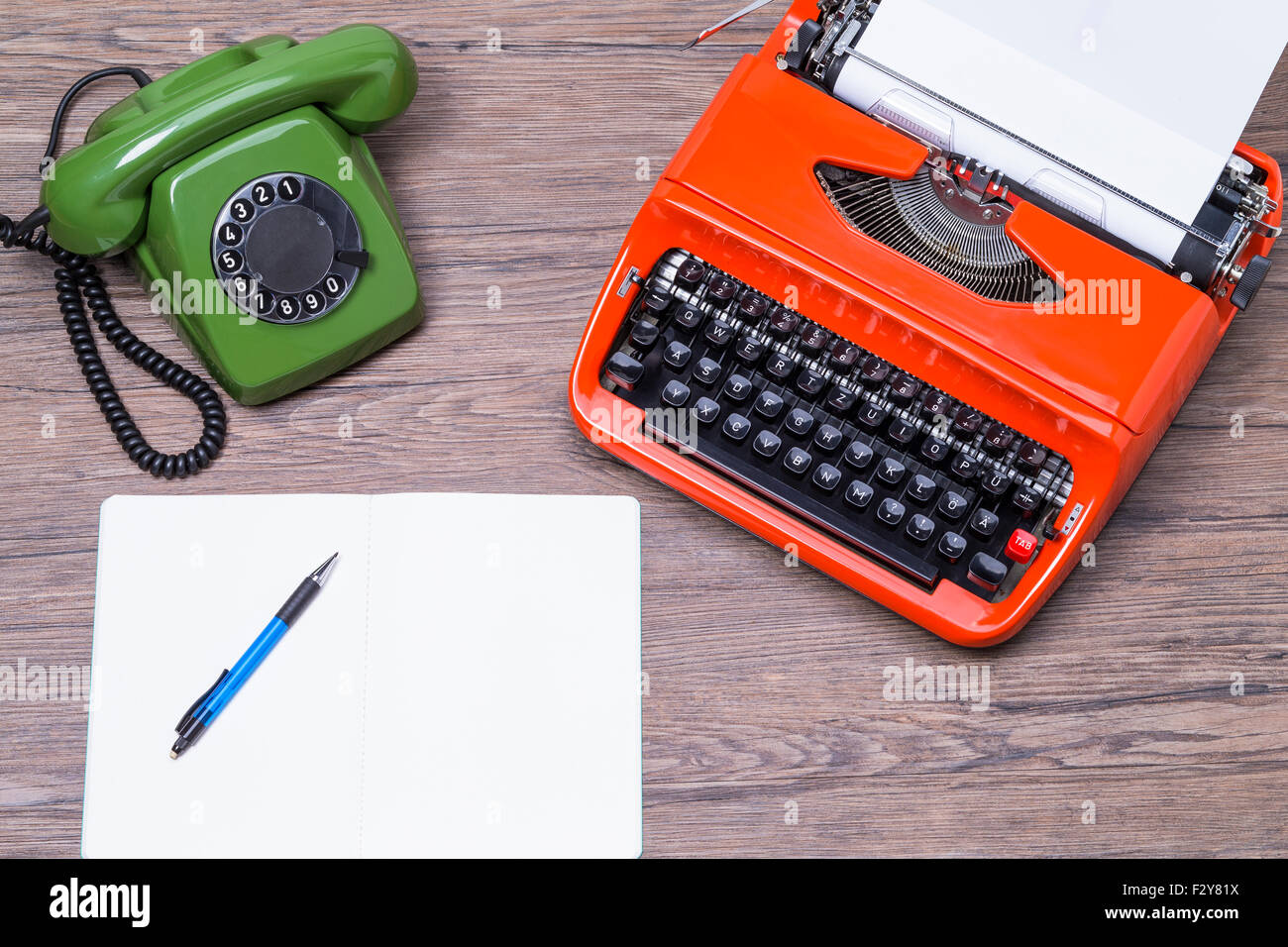 Retro phone and typewriter on a wooden table with top view Stock Photo ...