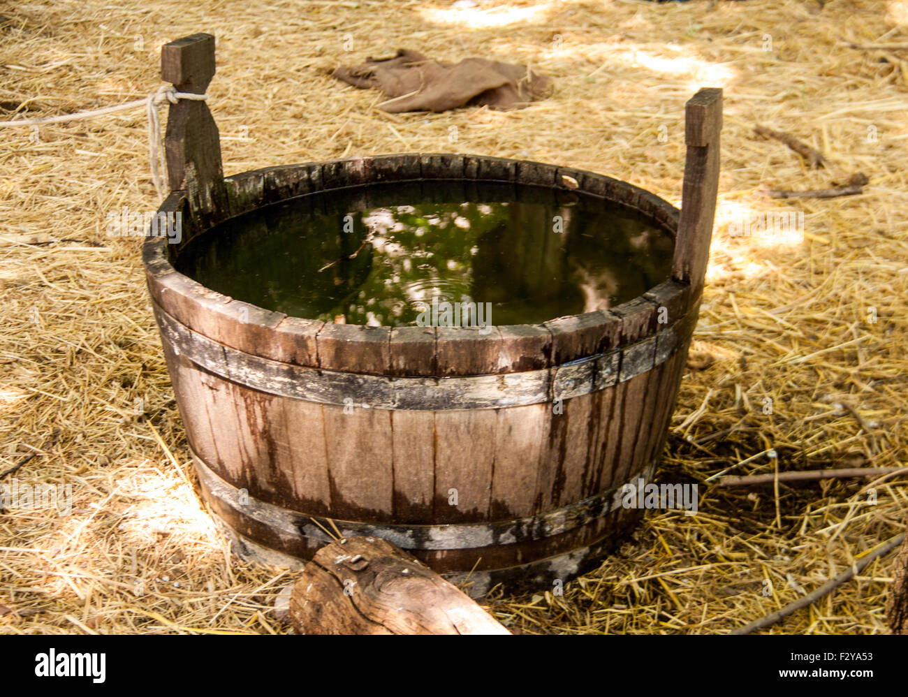 Antique bucket with water in the courtyard of a castle in Umbria, Italy ...