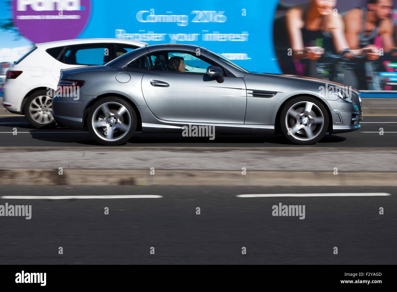 Side view of Mercedes SLK; Blurred moving vehicles on 'The Strand' at ...