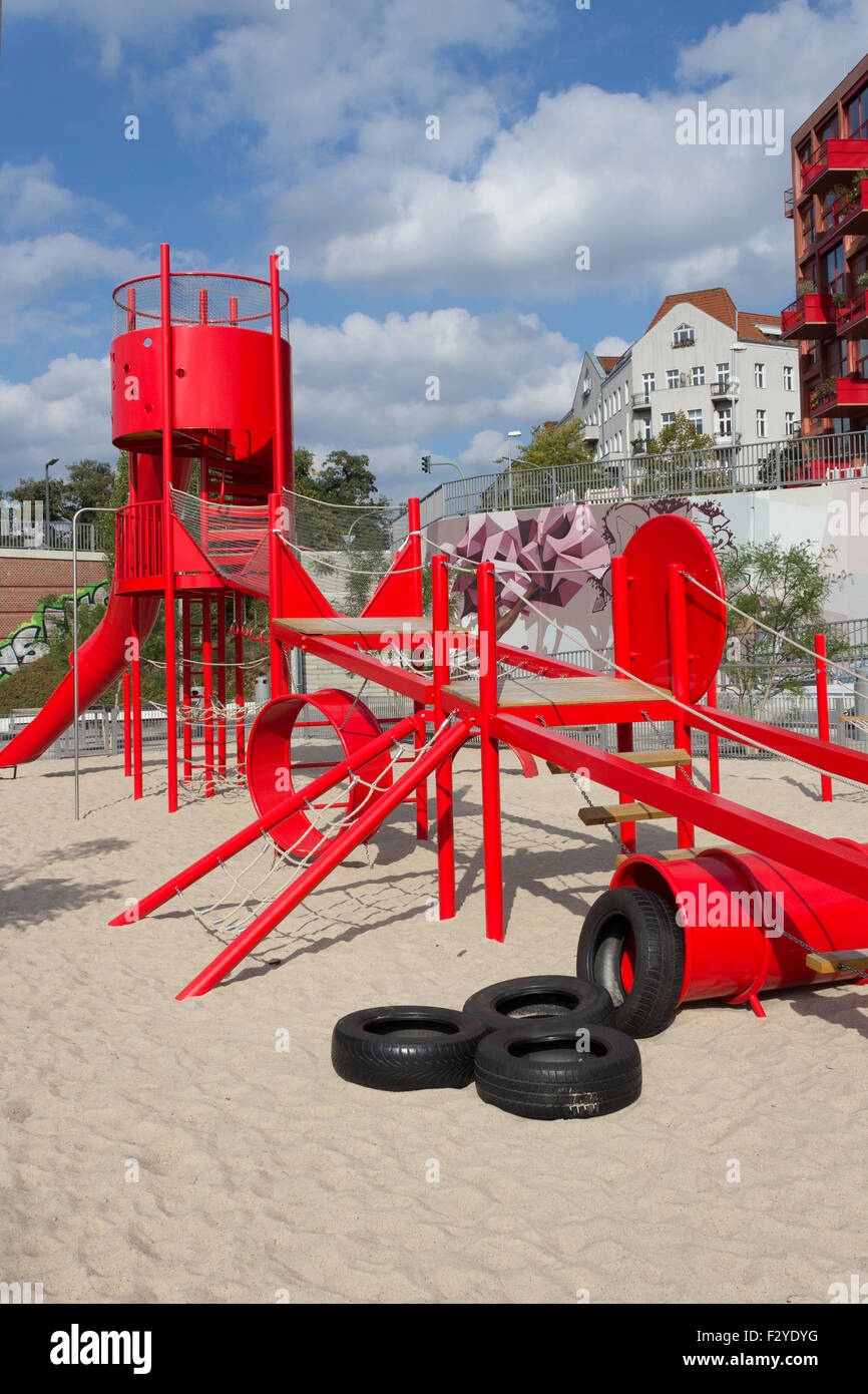 kids playground with red slide, climber and sandpit Stock Photo - Alamy