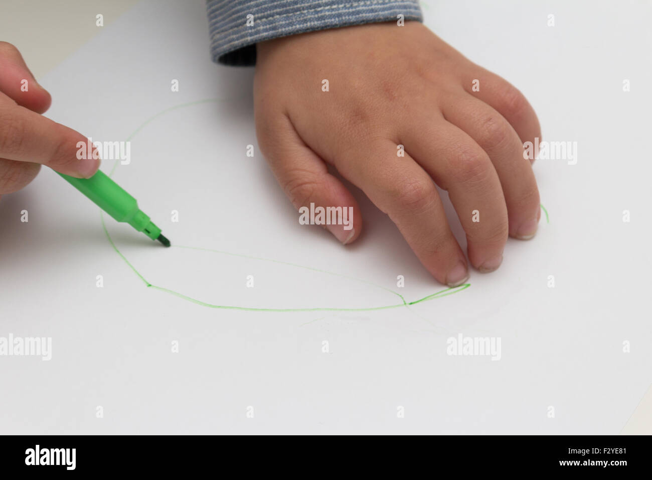 Boy Drawing On Paper With Pen Stock Photos & Boy Drawing On Paper With ...