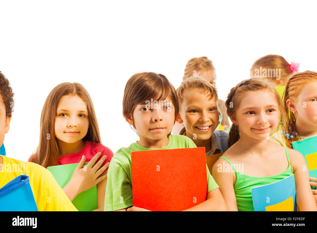 Calm kids standing with textbooks Stock Photo - Alamy