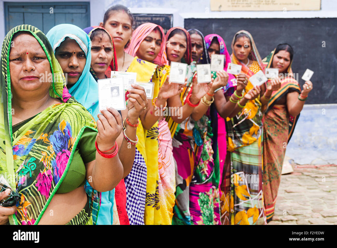 Showing smiling confidence standing looking at camera voting booth ...
