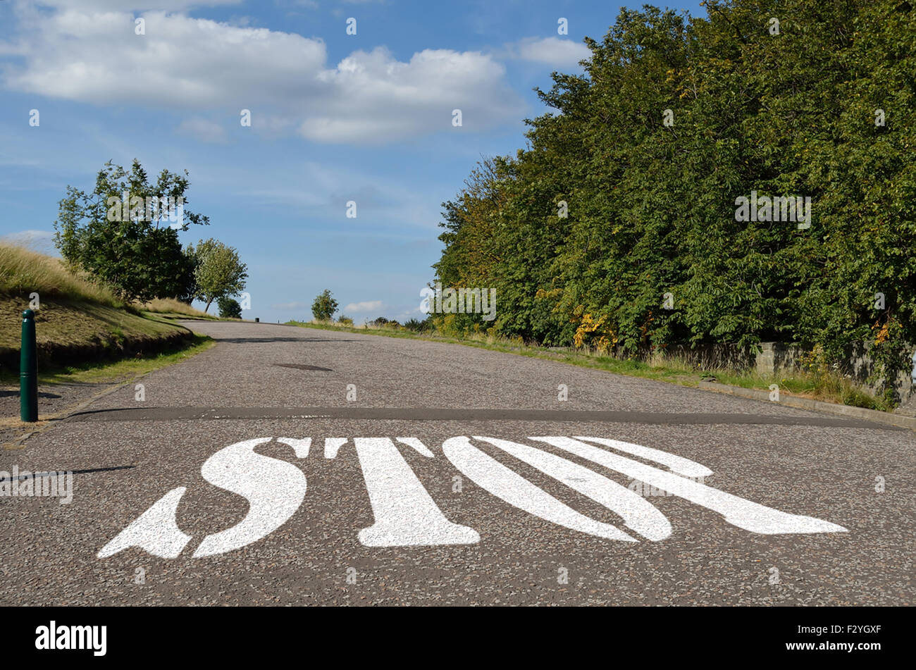 Stop text on highway Stock Photo - Alamy