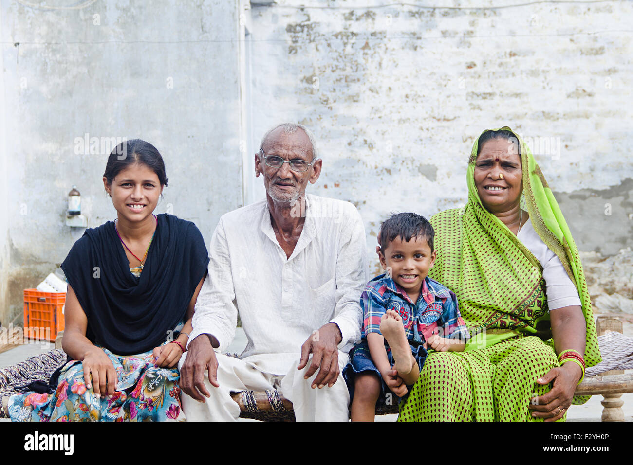 indian rural villager Parents and kids sitting Home Charpai Stock Photo ...
