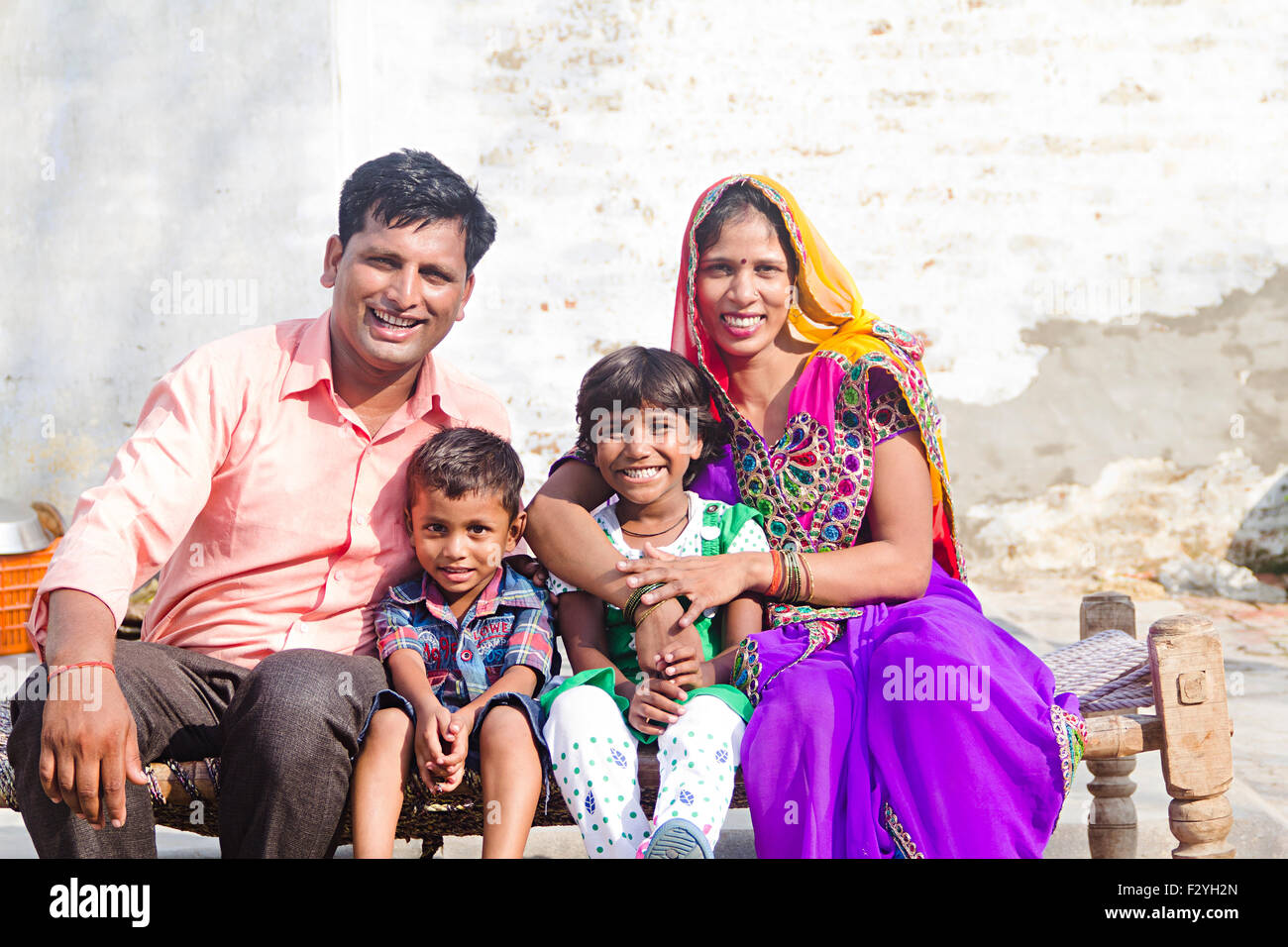 4 indian rural villager Parents and kids sitting home Charpai Stock ...