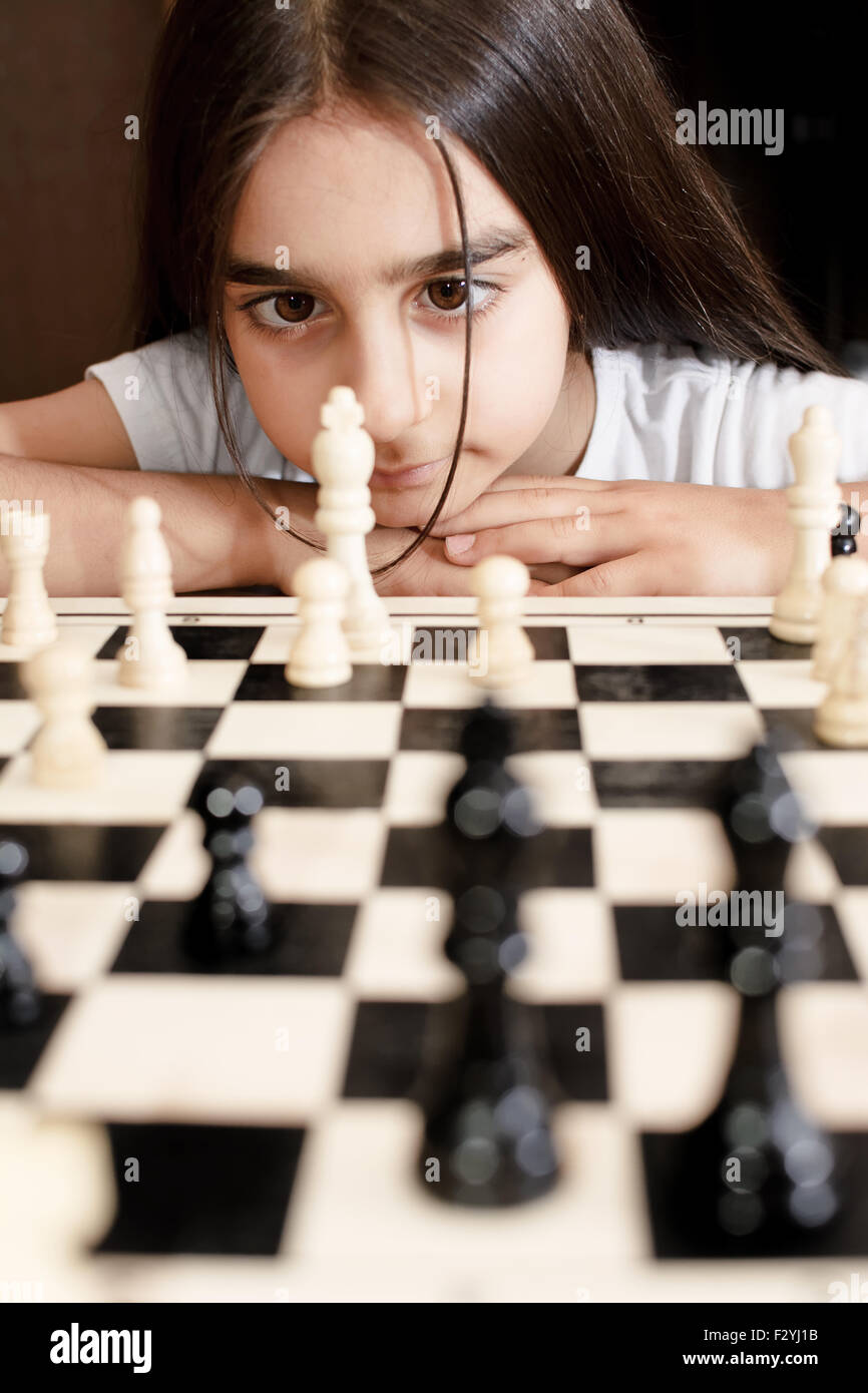 beautiful little girl concentrated playing chess Stock Photo - Alamy