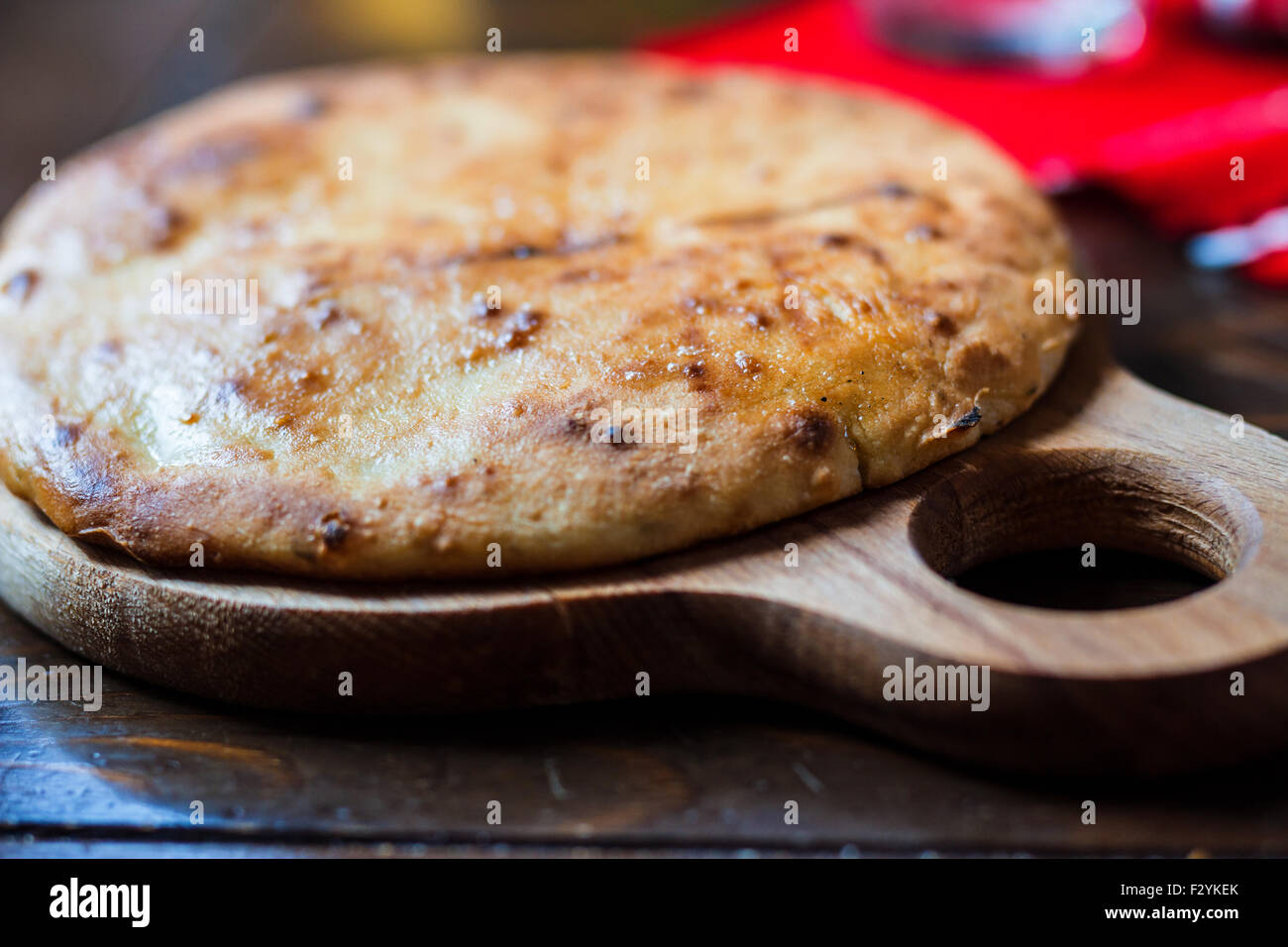 Hot Tasty bread cake with yellow cheese made in fire furnace of bakery ...
