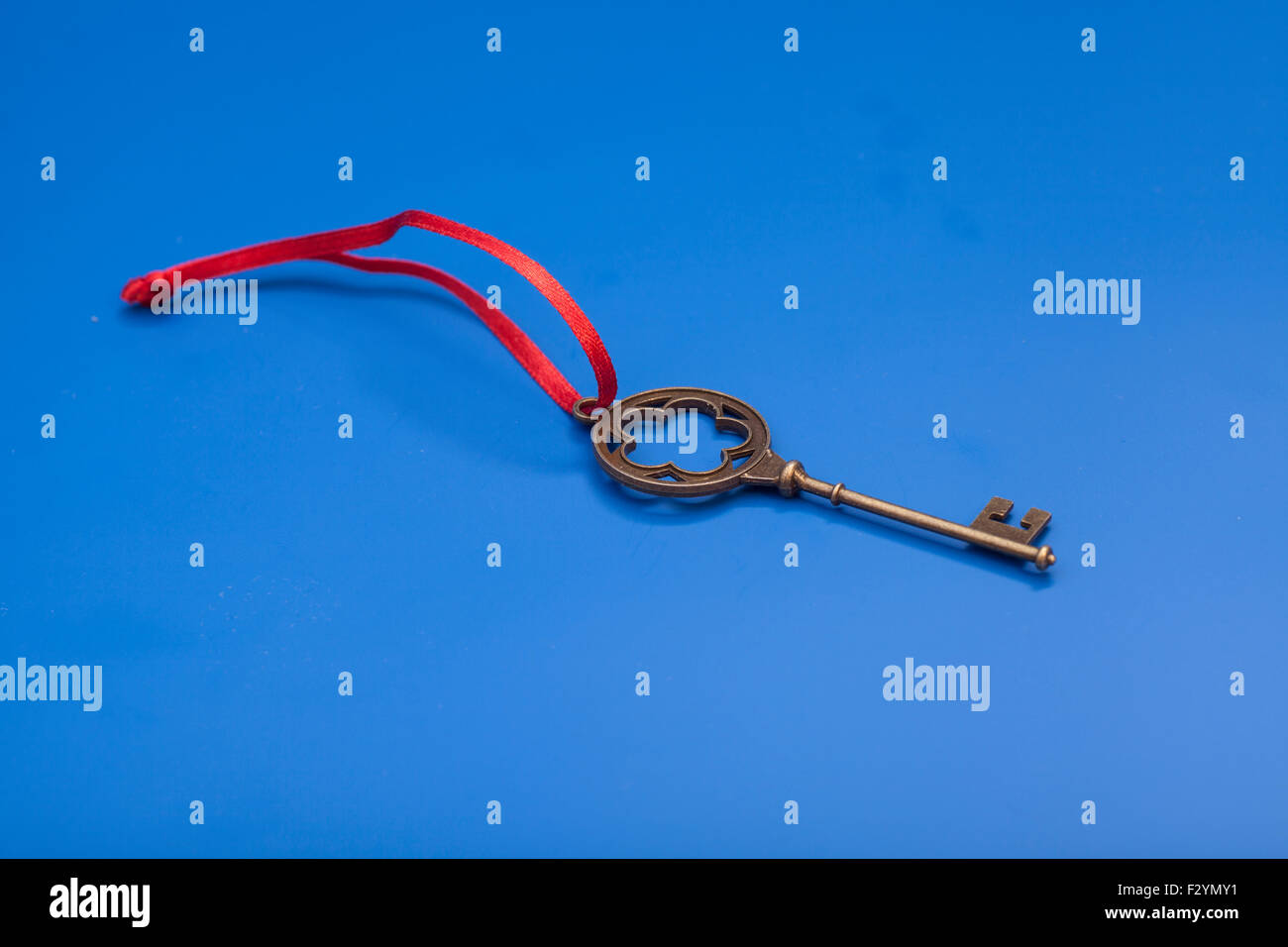 Key To Success With Red Bow isolated on blue background Stock Photo - Alamy