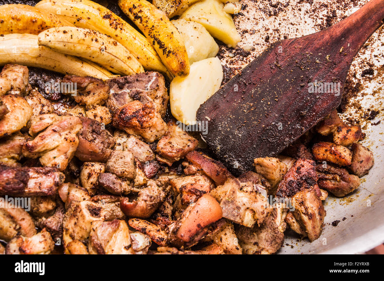 Closeup typical Ecuadorian food preparation, pieces of pork and baby ...