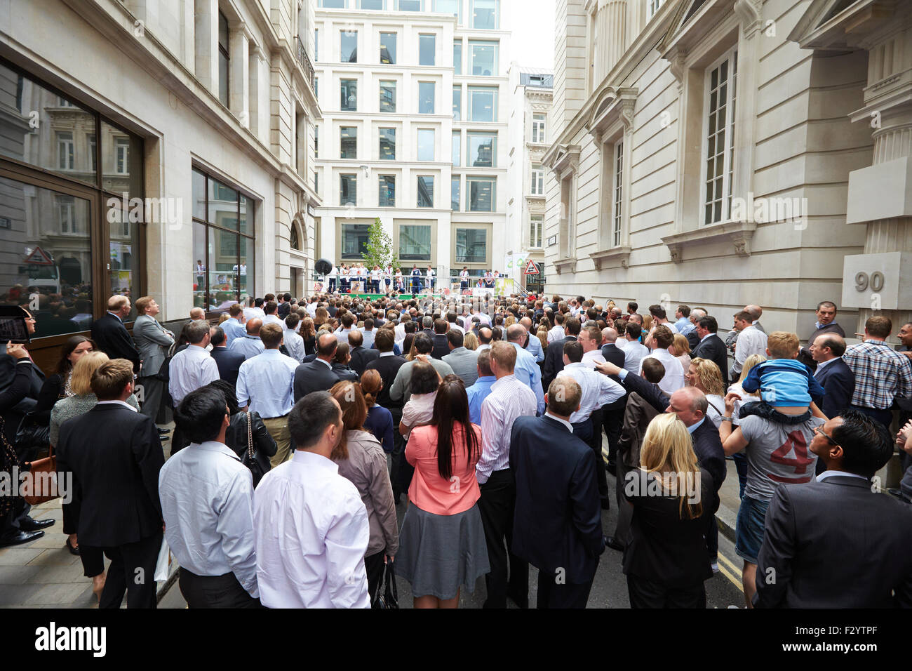 A large crowd of City workers and well-wishers strain for a glimpse of ...