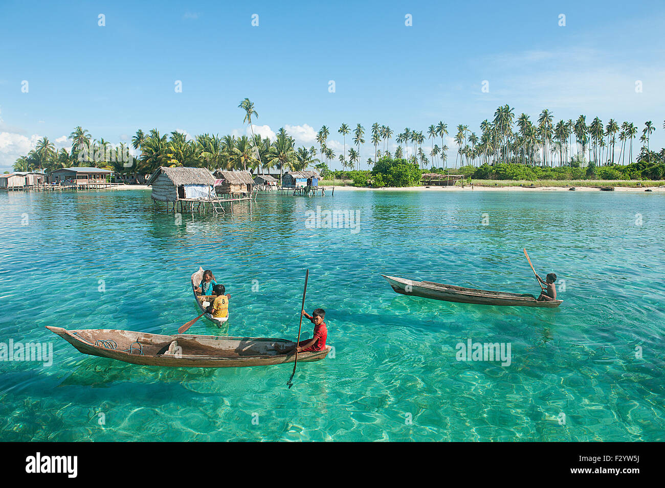 Unidentified Borneo Sea Gypsy kids on a canoes in Mabul Maiga Island ...