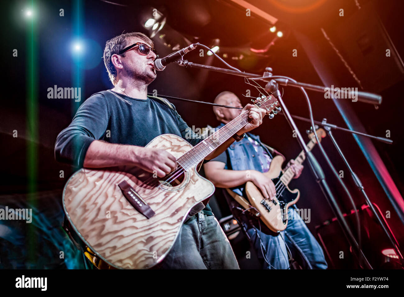 Band performs on stage, rock music concert. Warning - authentic ...