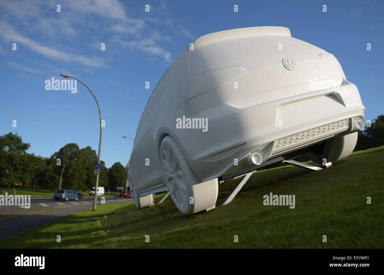 An oversized model of a Volkswagen Golf parked on a mound in Wolfsburg ...