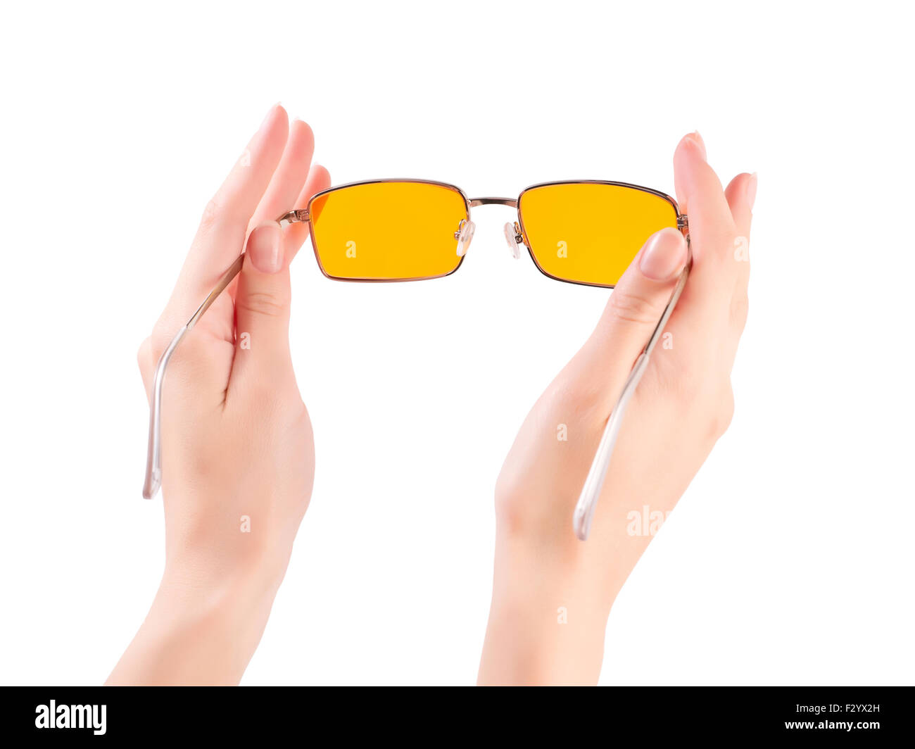 beautiful female hand with yellow driving glasses isolated on white ...