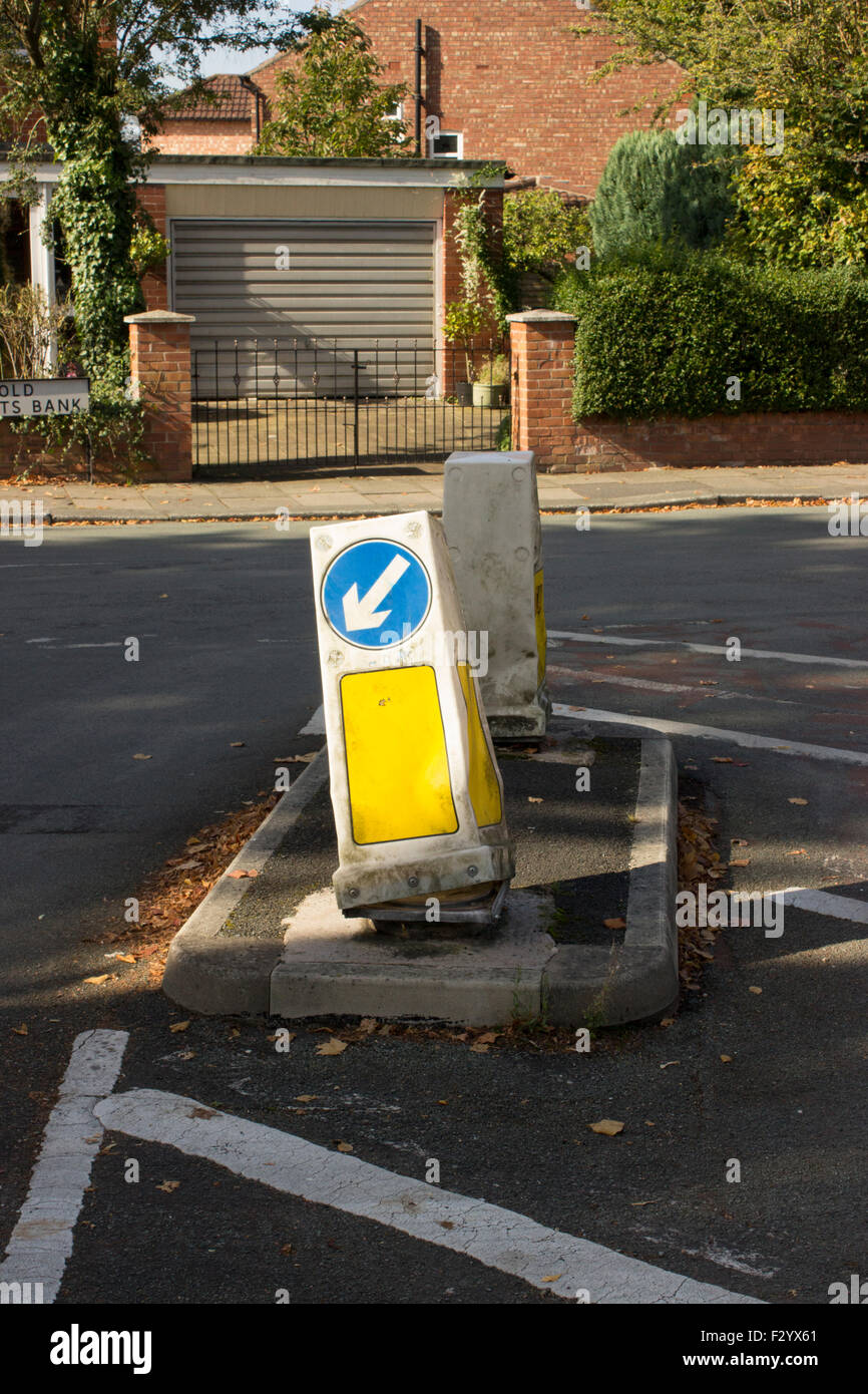 Traffic bollard sign in the middle of the road. Arrow pointing left in ...