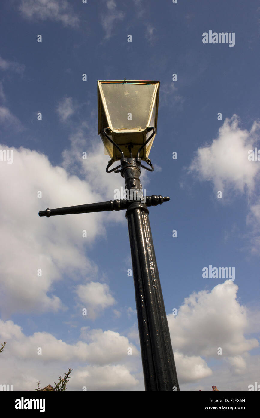 Old style gas burning streetlamp, lantern, with a black post and a gold ...