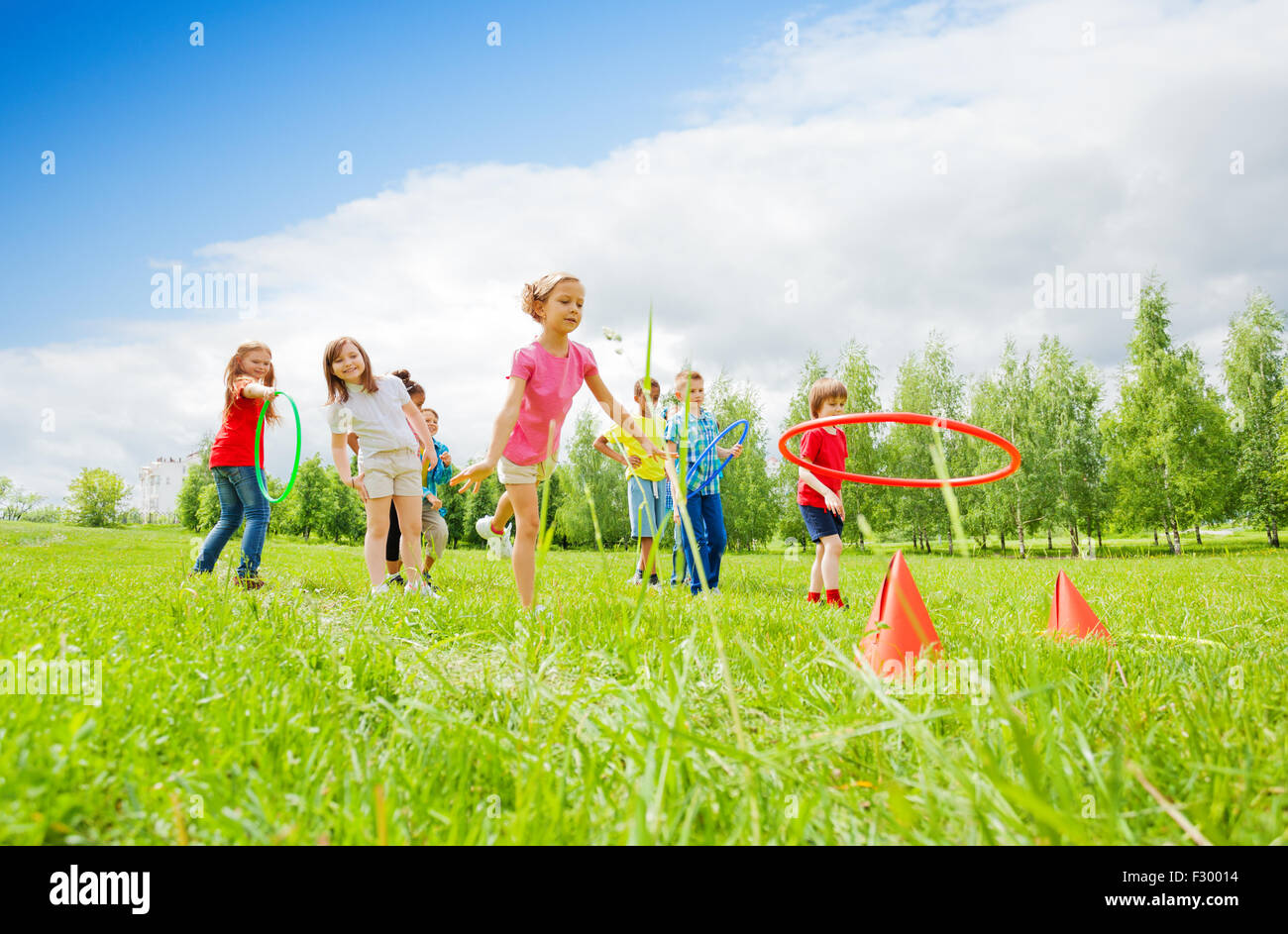 Two teams playing and throwing colorful hoops Stock Photo - Alamy